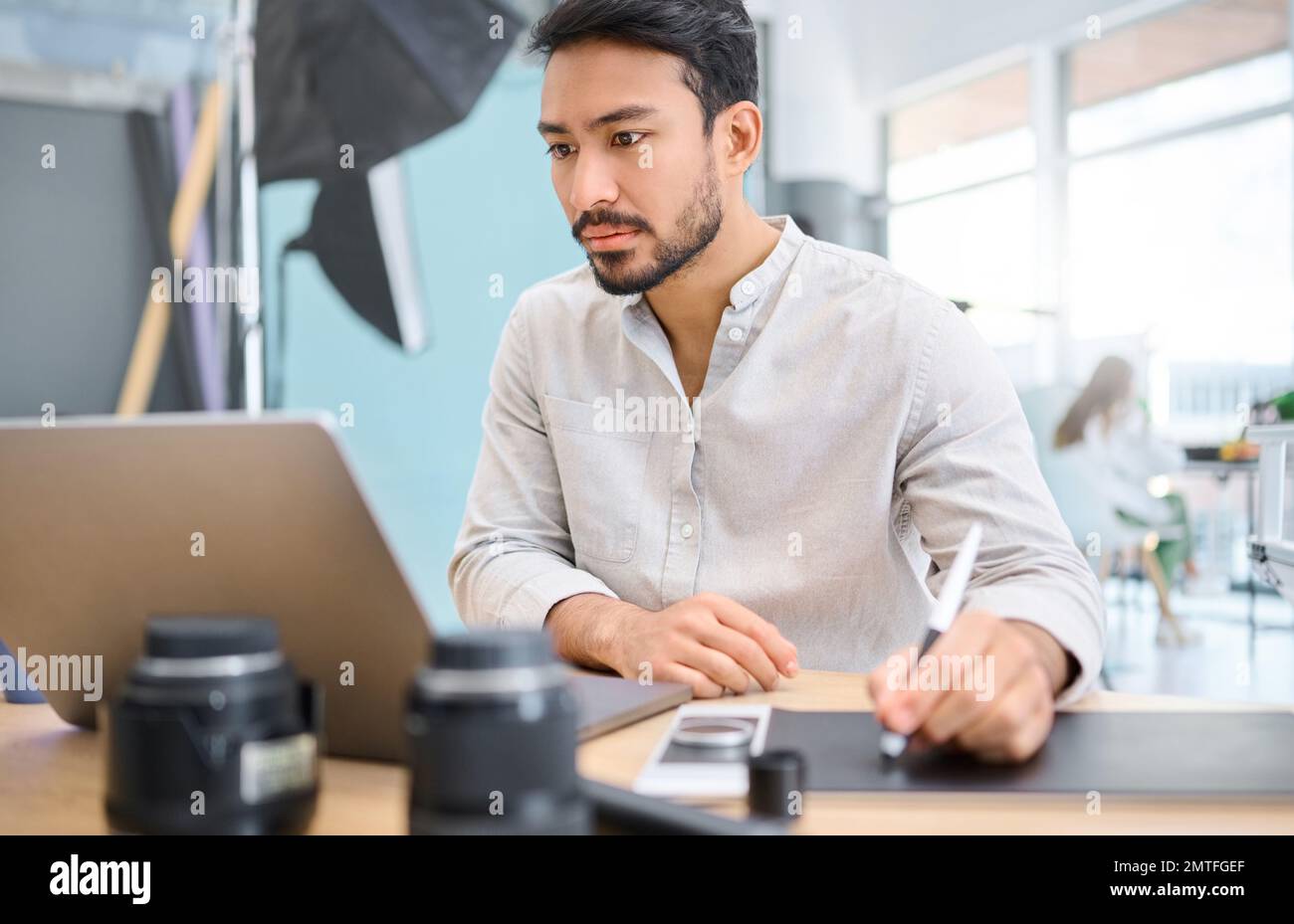 Graphic tablet, laptop and photographer editing photoshoot, focus on ...