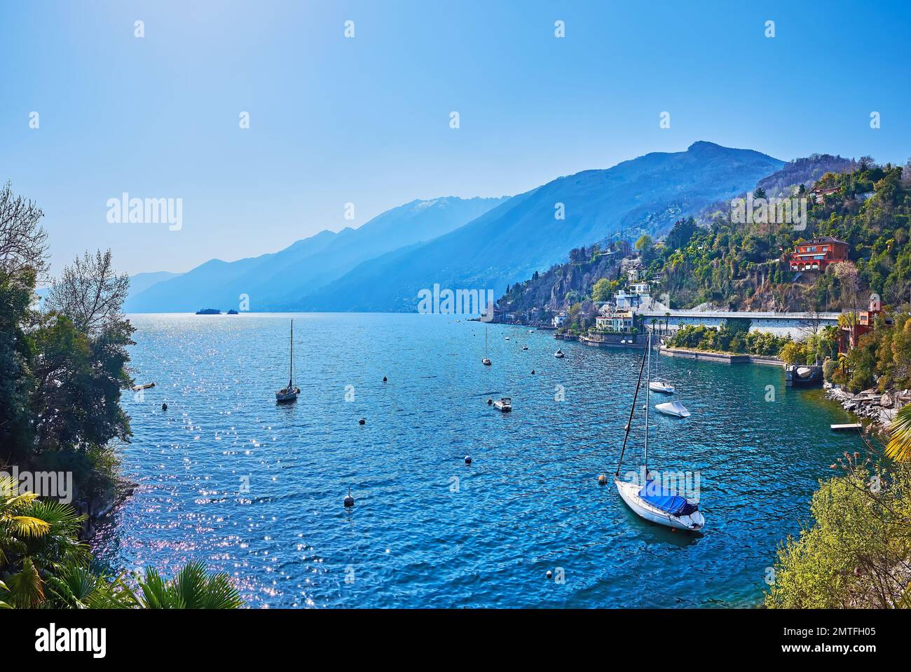 Beautiful harbor on Lake Maggiore with moored yachts, small boats and ...