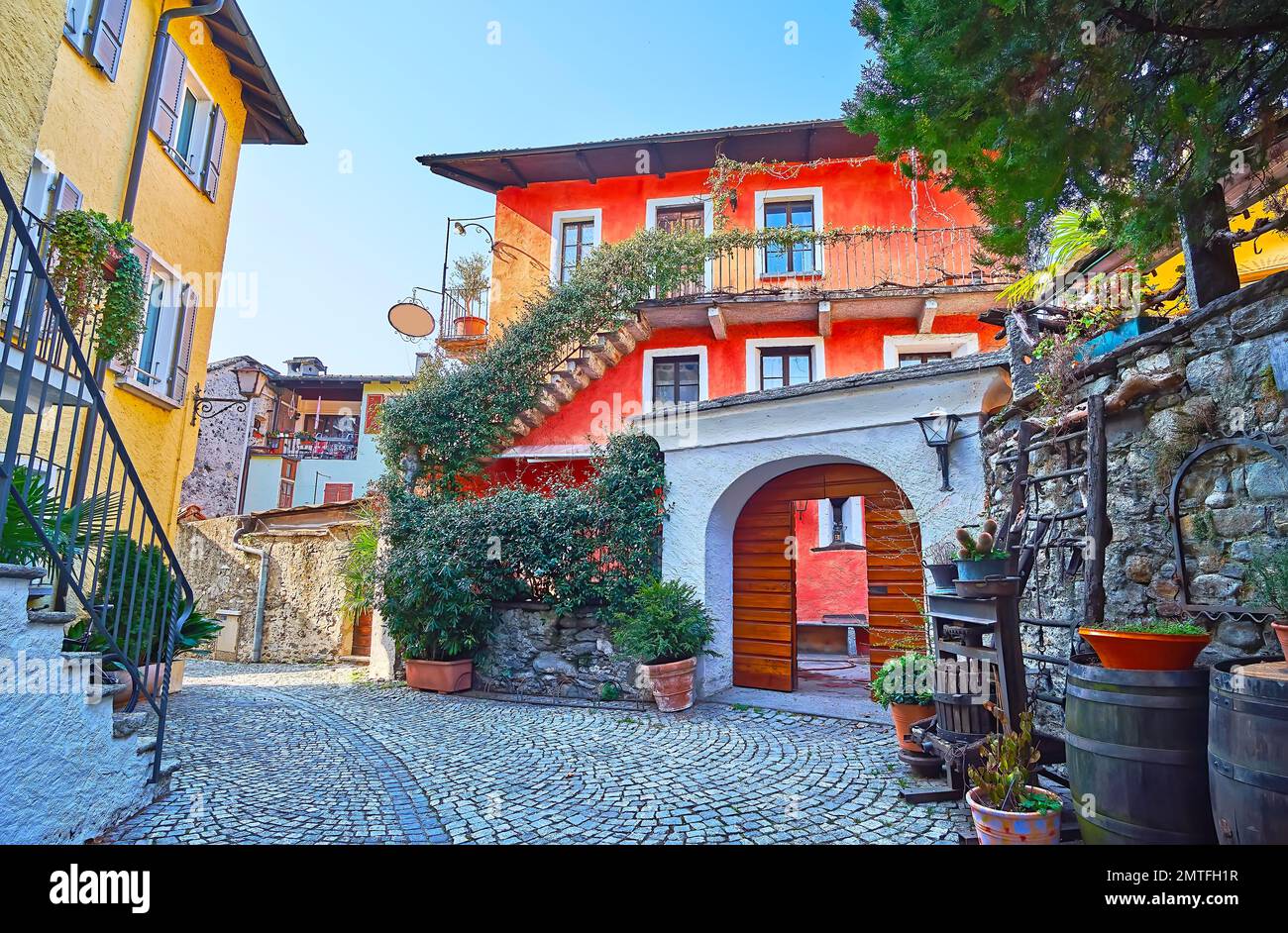 Walk down narrow winding Via Sant'Omobono with vintage colored houses ...