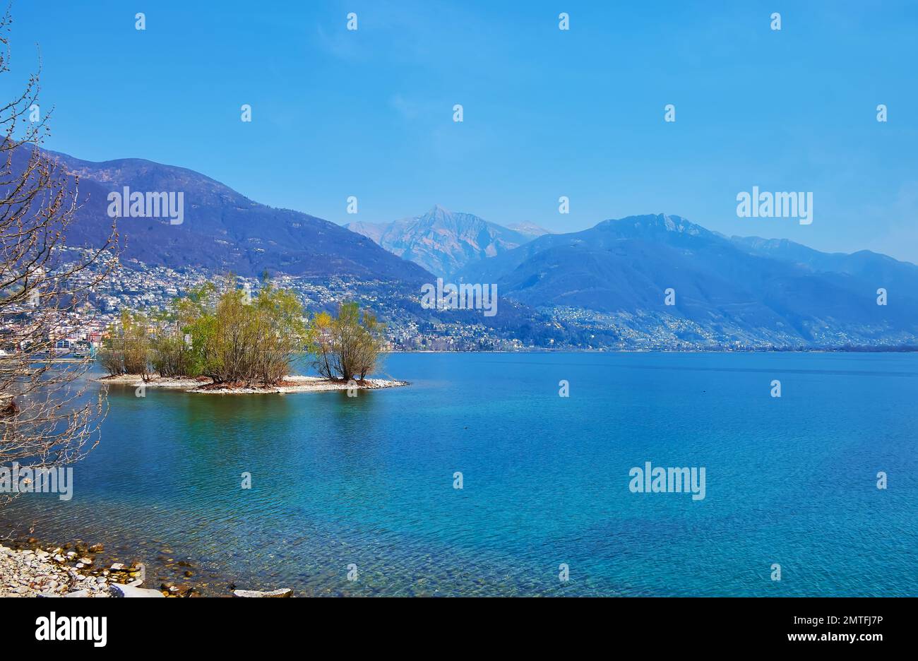 Azure waters of Lake Maggiore with a view on tiny islet against the ...