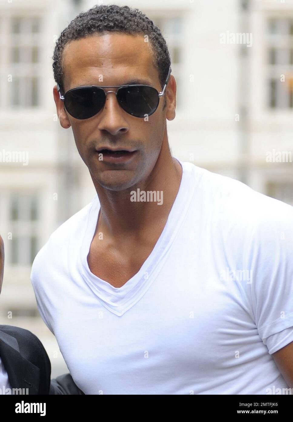English footballer Rio Ferdinand poses with fans after leaving his ...
