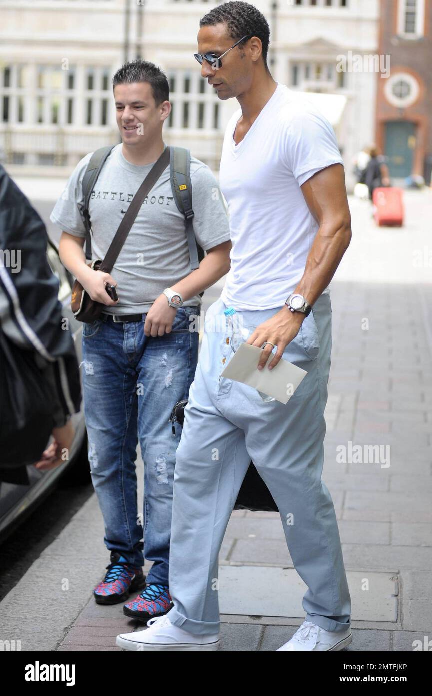 English footballer Rio Ferdinand poses with fans after leaving his ...