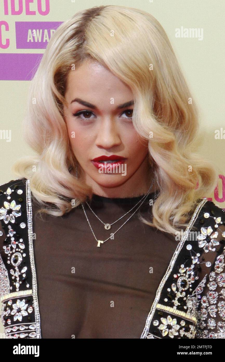 Wearing a stone encrusted jump-suit with a sheer plunging neckline ...