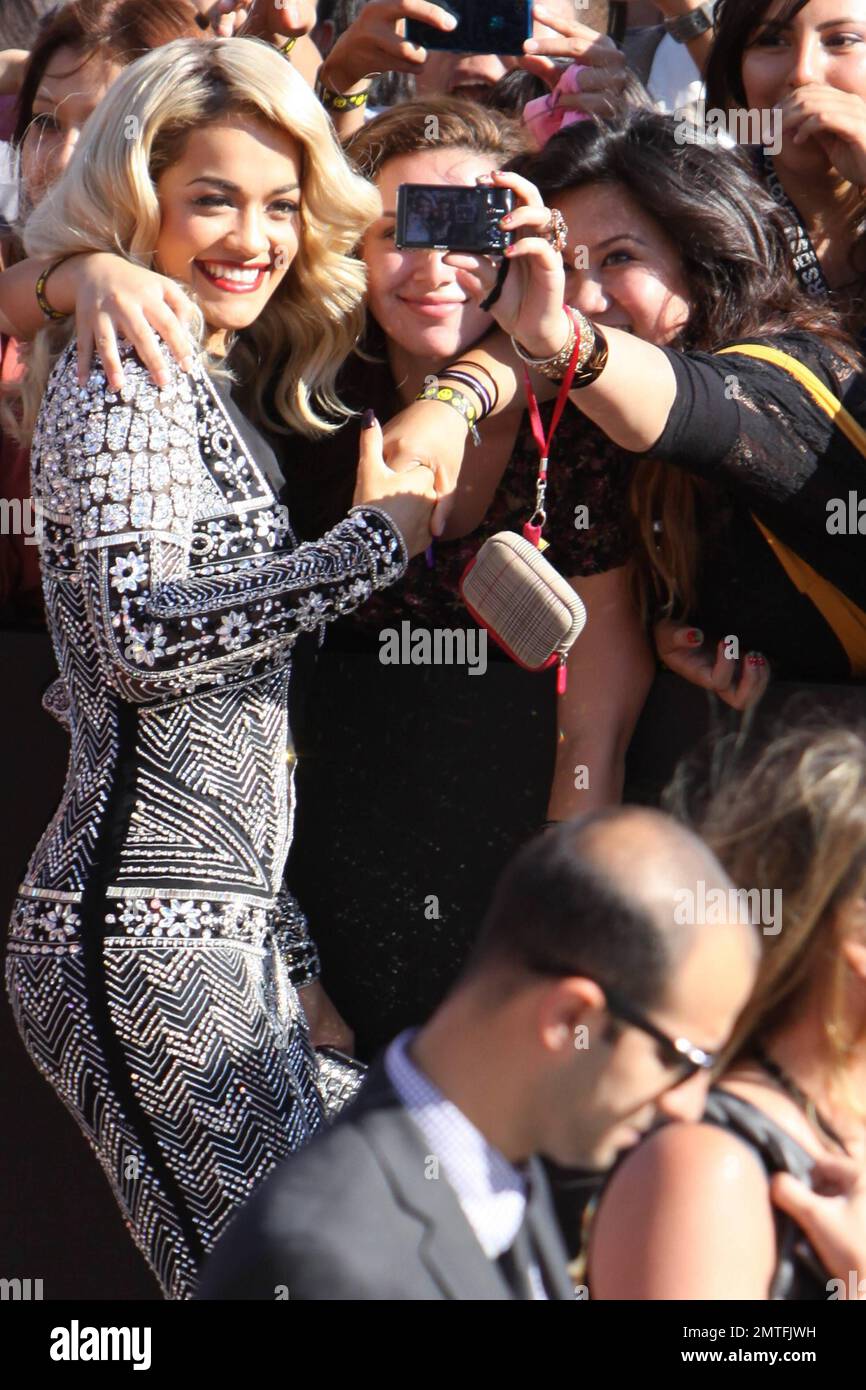 Wearing a stone encrusted jump-suit with a sheer plunging neckline ...