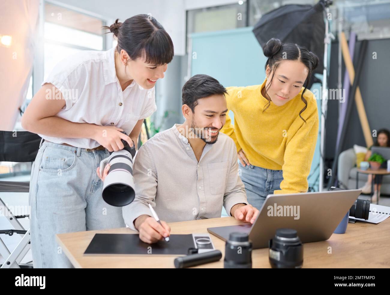 Photographer, collaboration and laptop with a designer team working on ...