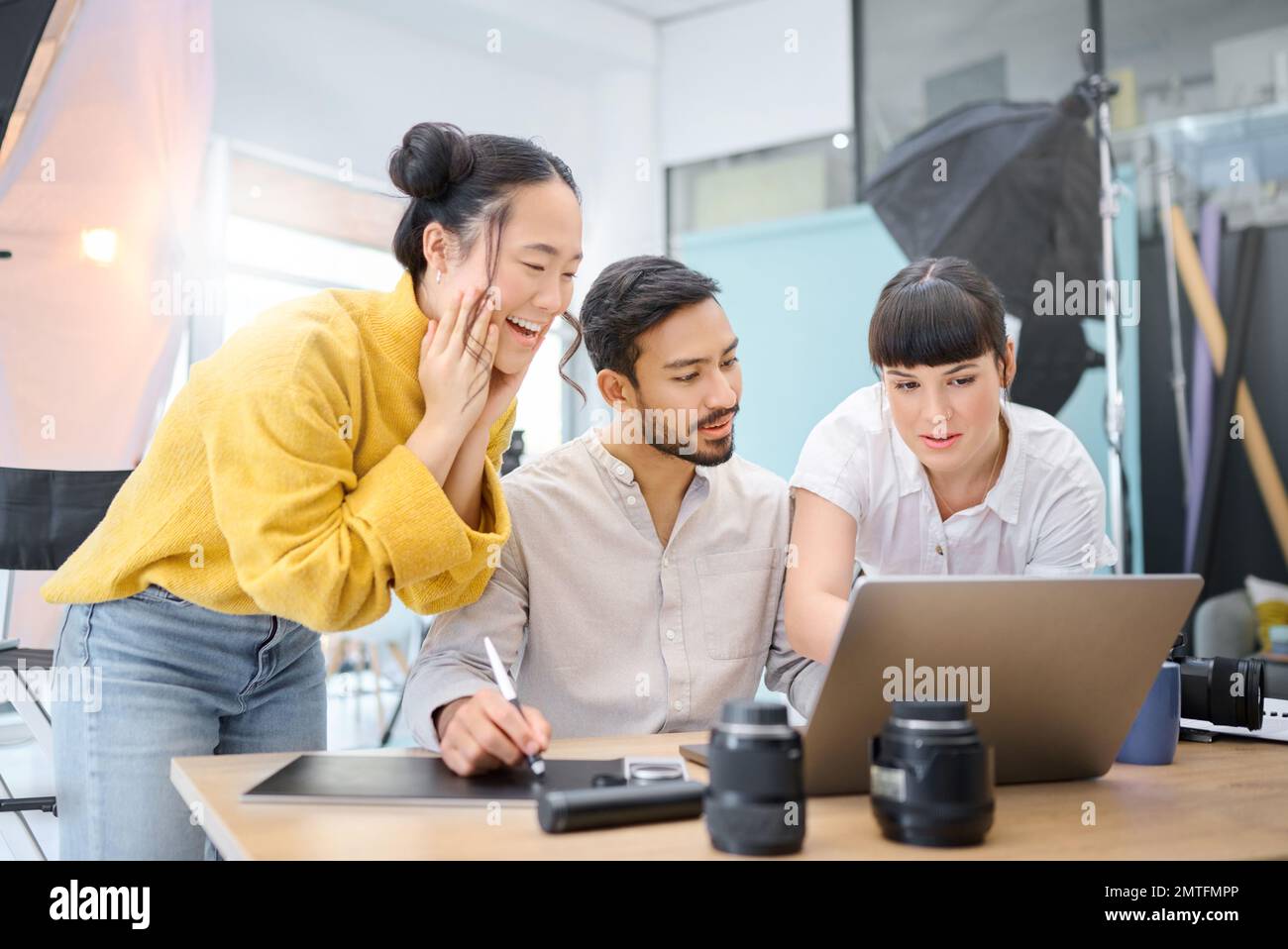 Photography, collaboration and laptop with a designer team working on a ...