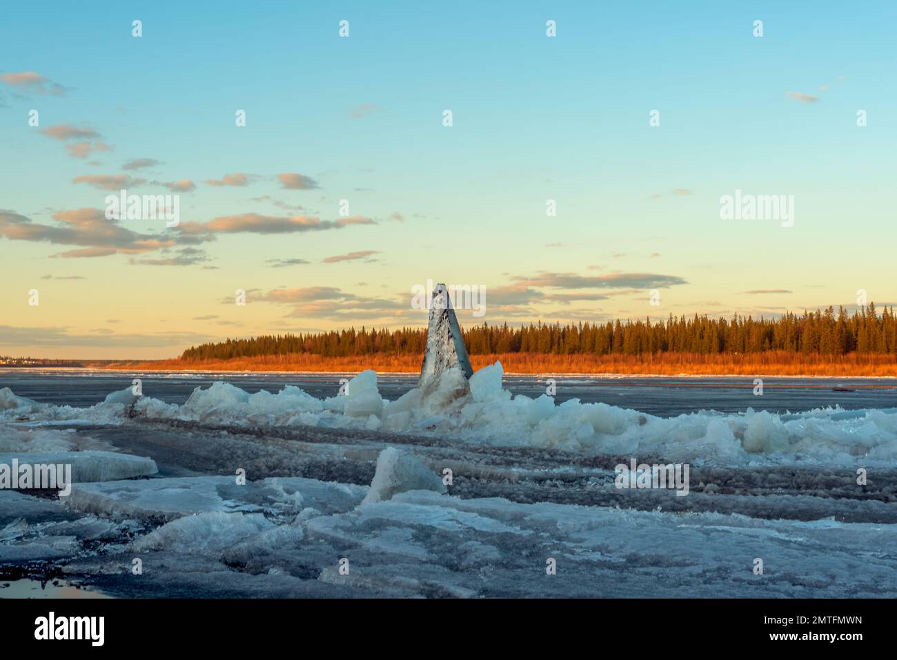 Ice drift. An ice floe in the form of a shark's fin with a reflection ...