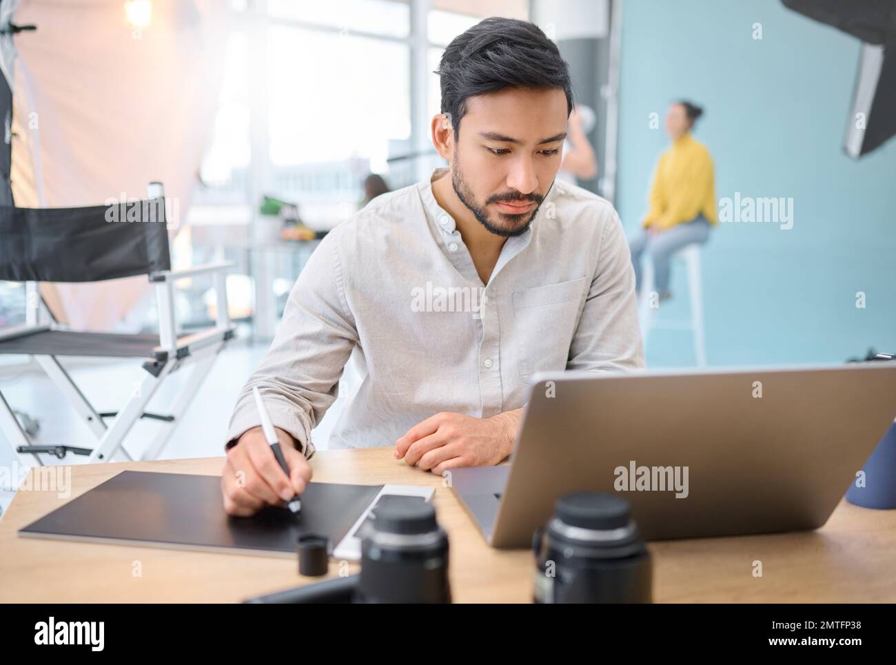 Graphic tablet, laptop and photography man editing photoshoot, focus on ...