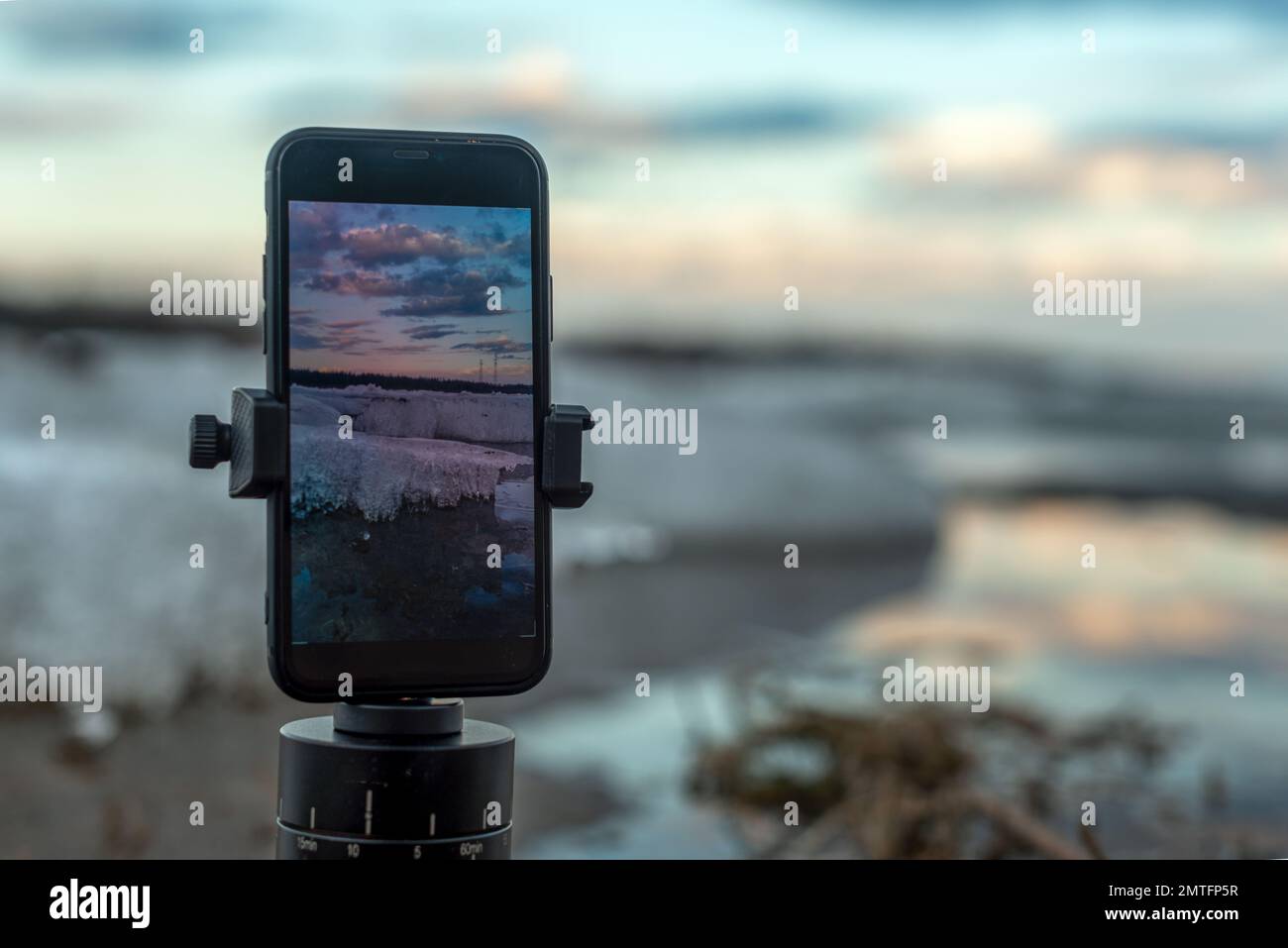 The screen of a mobile phone takes a time-lapse of the spring ice drift ...