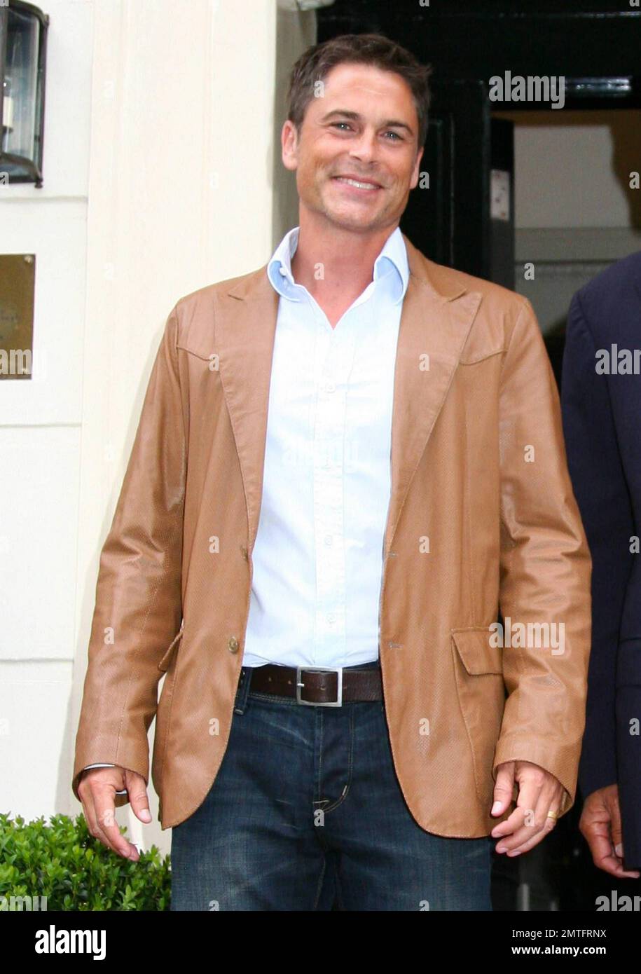 Actor Rob Lowe waves to photographers as he leaves a private members ...