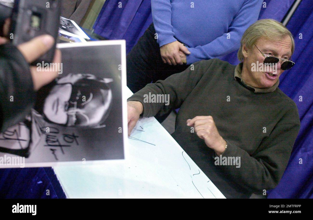 FILE - In this Feb. 23, 2002 file photo, a fan holds a signed ...