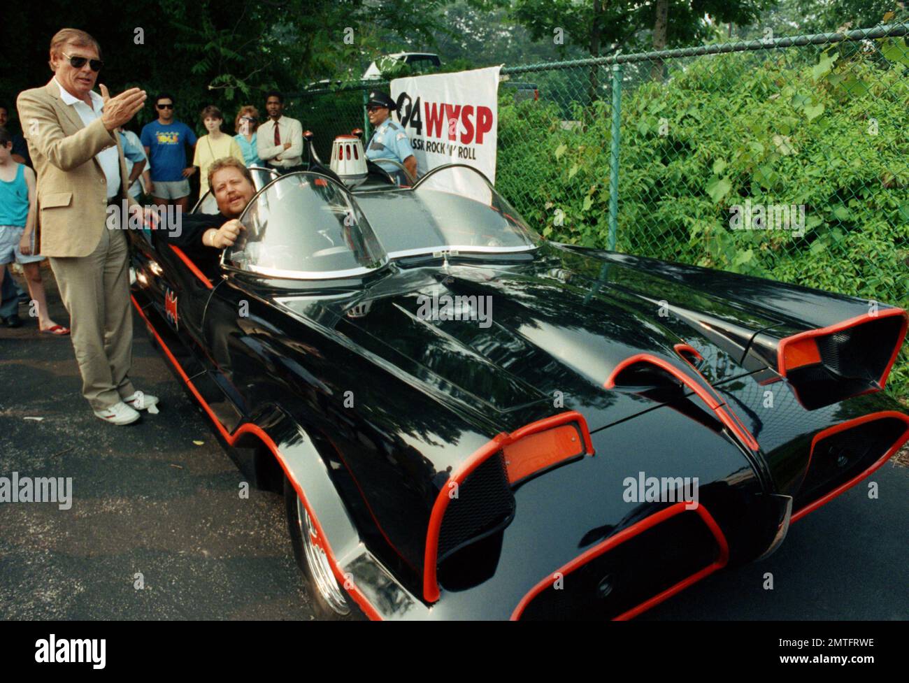 FILE - In this June 27, 1989 file photo, Adam West, left, stands beside ...