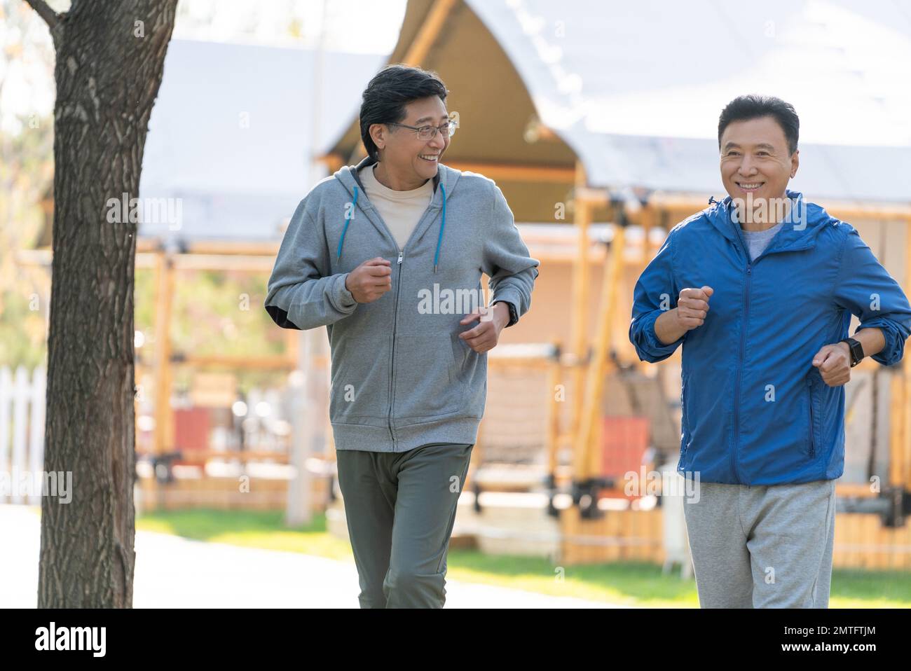 Two wear sports watch old man running fitness in the woods Stock Photo ...