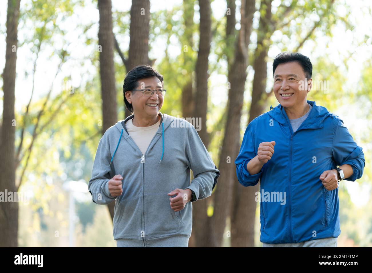 Two wear sports watch old men running in the gym Stock Photo - Alamy