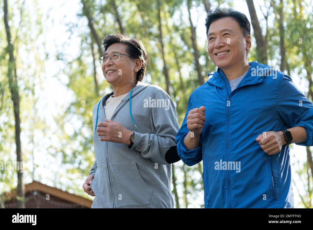 Two wear sports watch old men running in the gym Stock Photo - Alamy
