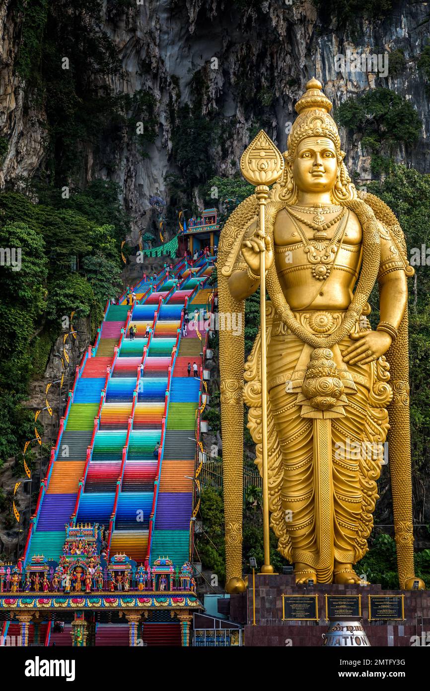 The golden Buddha and colorful stairs in front of the Batu Caves, Kuala ...