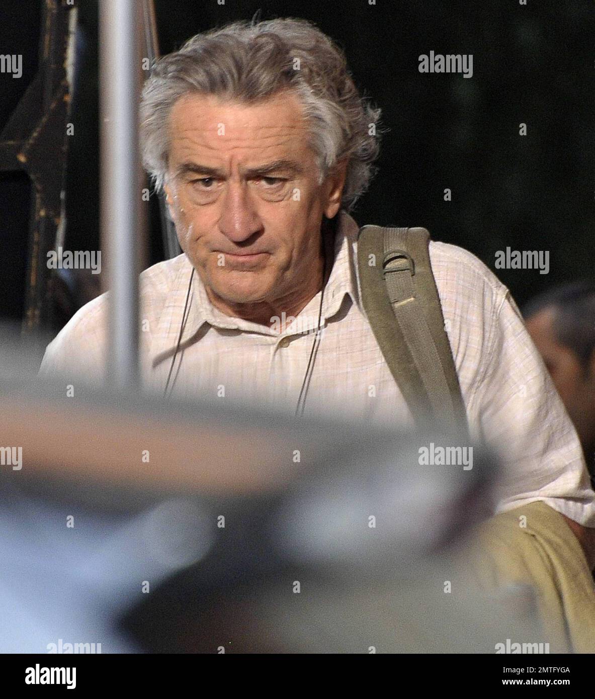 Veteran actor Robert De Niro walks to a waiting car after filming on ...
