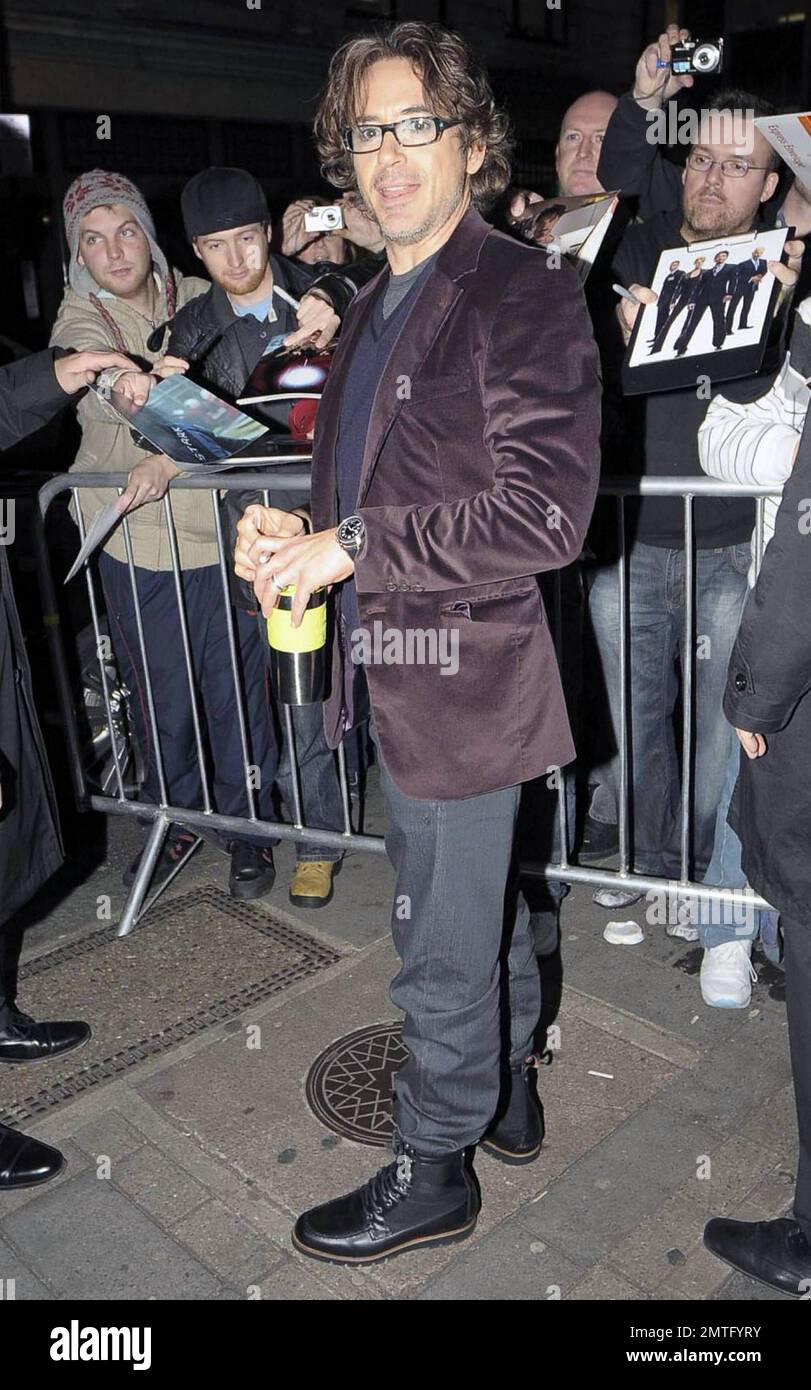 In a maroon smoking jacket and pants tucked into trendy combat boots ...