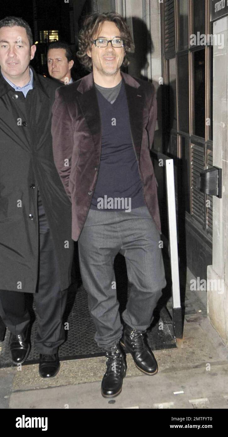 In a maroon smoking jacket and pants tucked into trendy combat boots ...