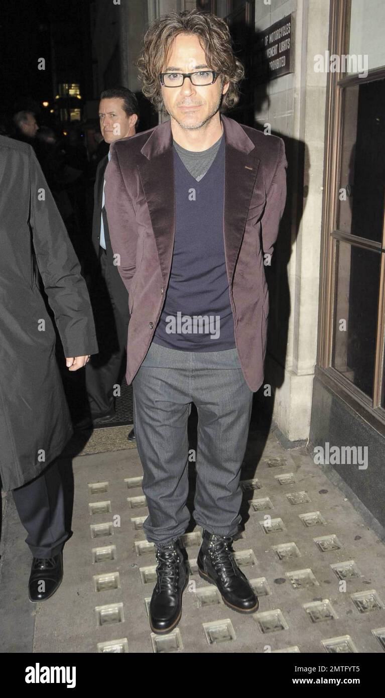 In a maroon smoking jacket and pants tucked into trendy combat boots ...