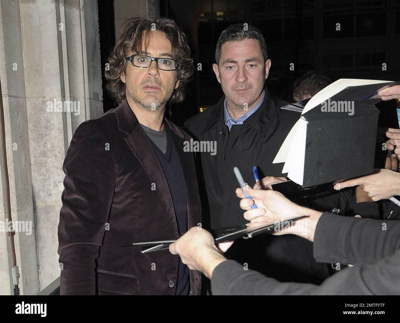 In a maroon smoking jacket and pants tucked into trendy combat boots ...