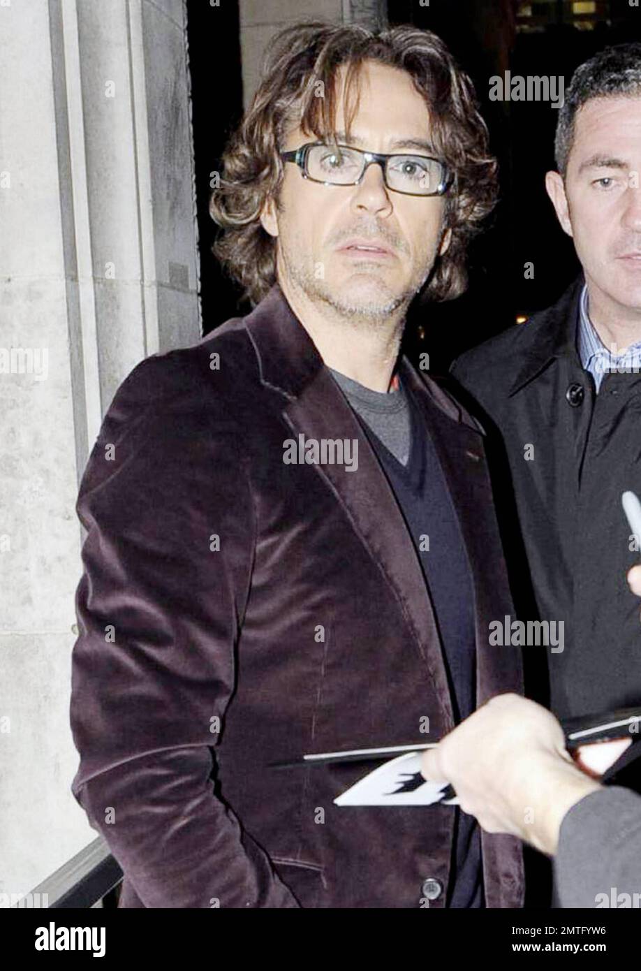 In a maroon smoking jacket and pants tucked into trendy combat boots ...