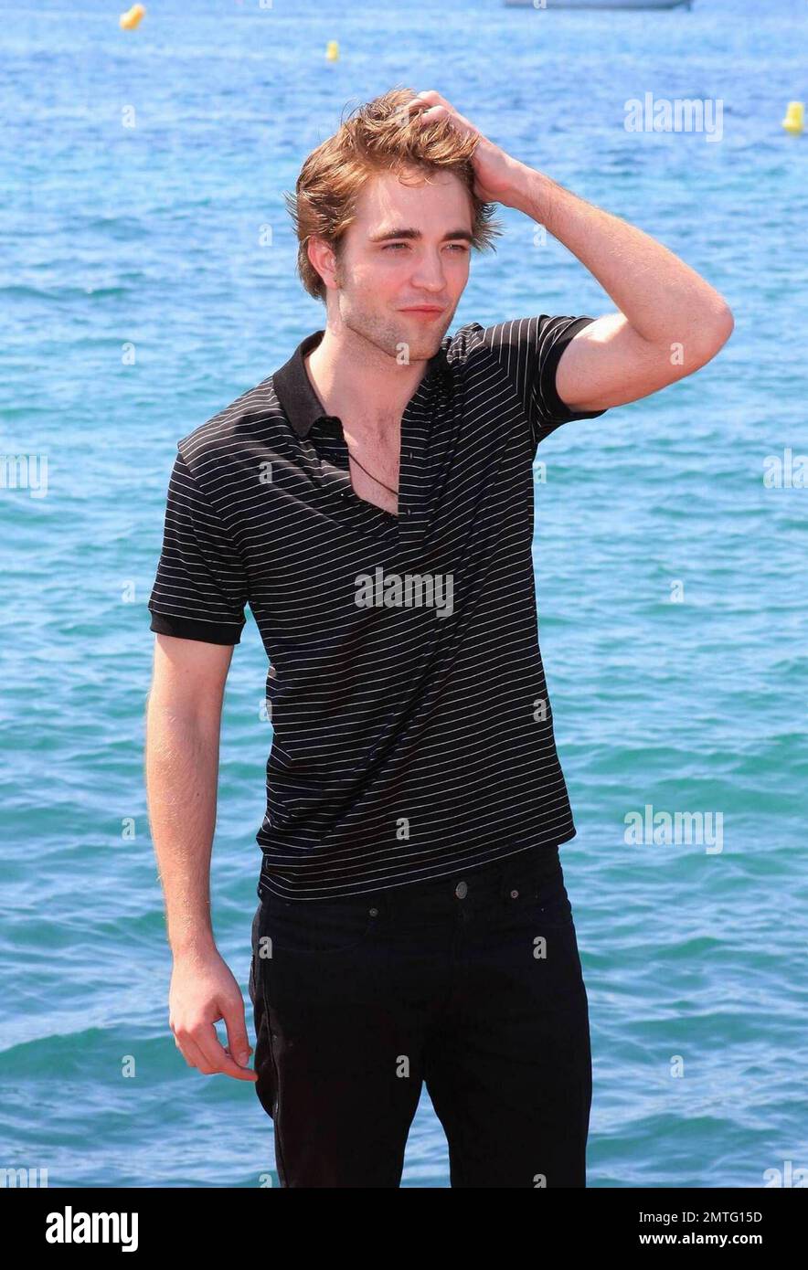 Robert Pattinson poses for the cameras at the Cannes Film Festival. The ...