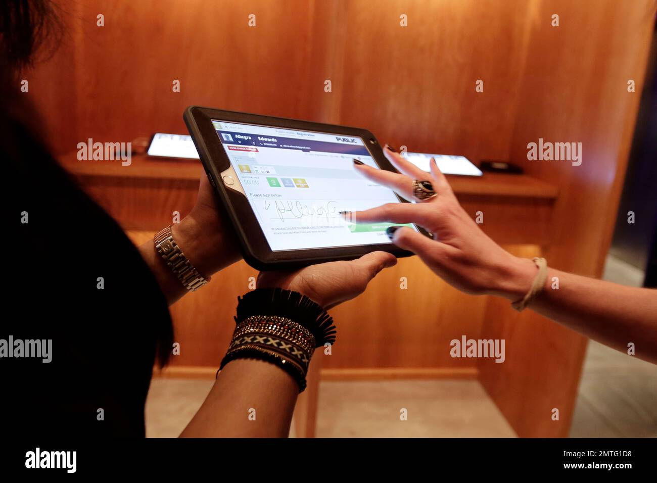 This June 1, 2017 photo shows a guest signing-in for her room using a ...