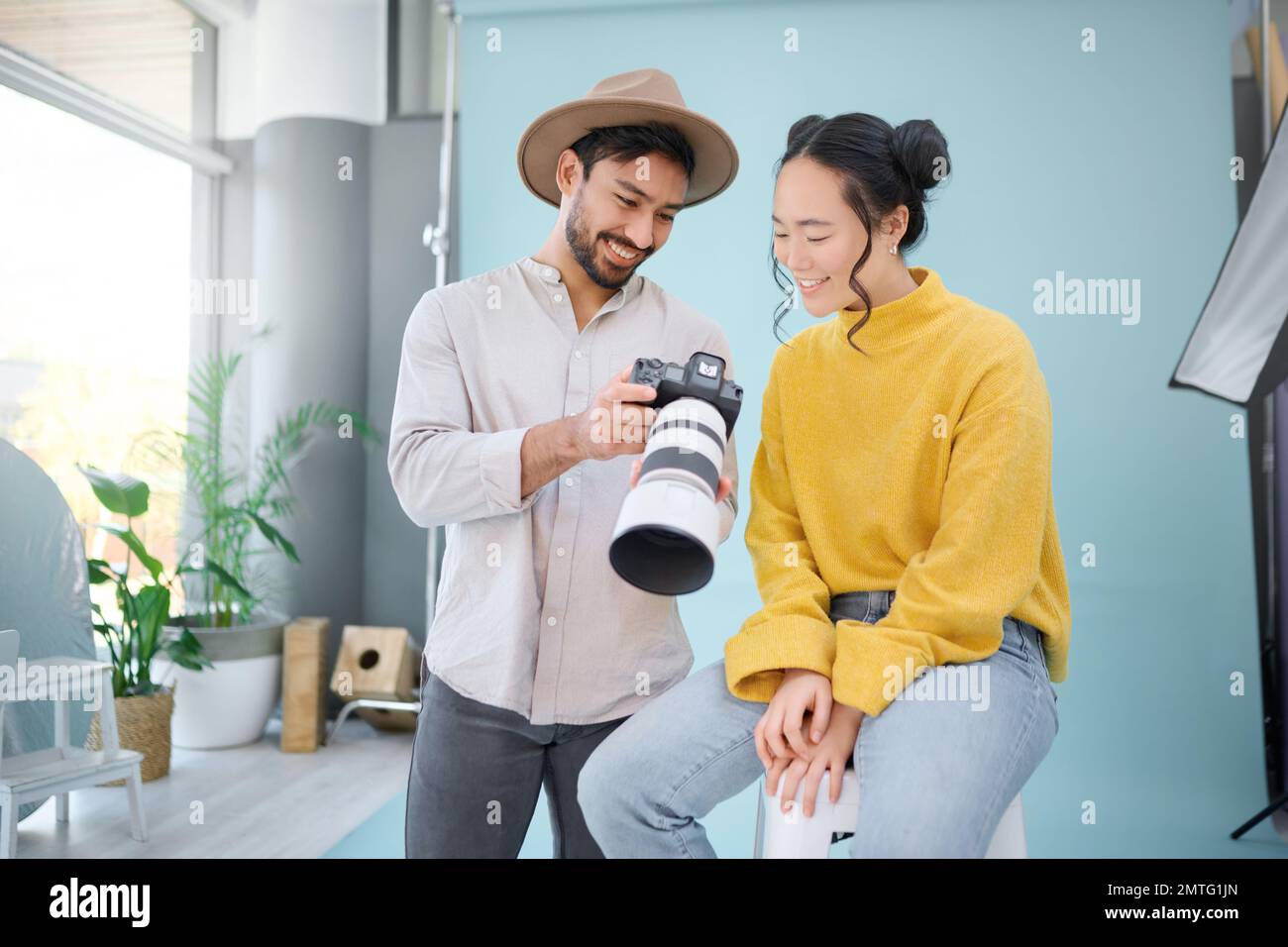 Creative, photographer and model choosing a picture on the camera from ...