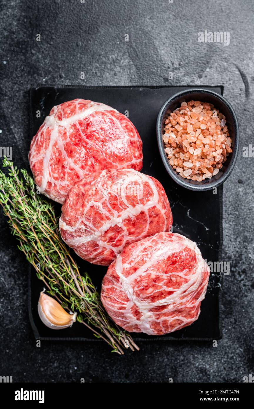 Raw Atriaux cutlets, ground pork wrapped in caul fat, swiss sausage ...