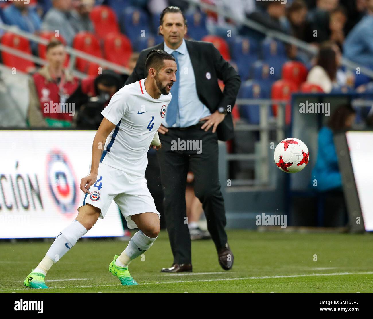 Chile's head coach Juan Antonio Pizzi looks at Chile's Mauricio Isla ...