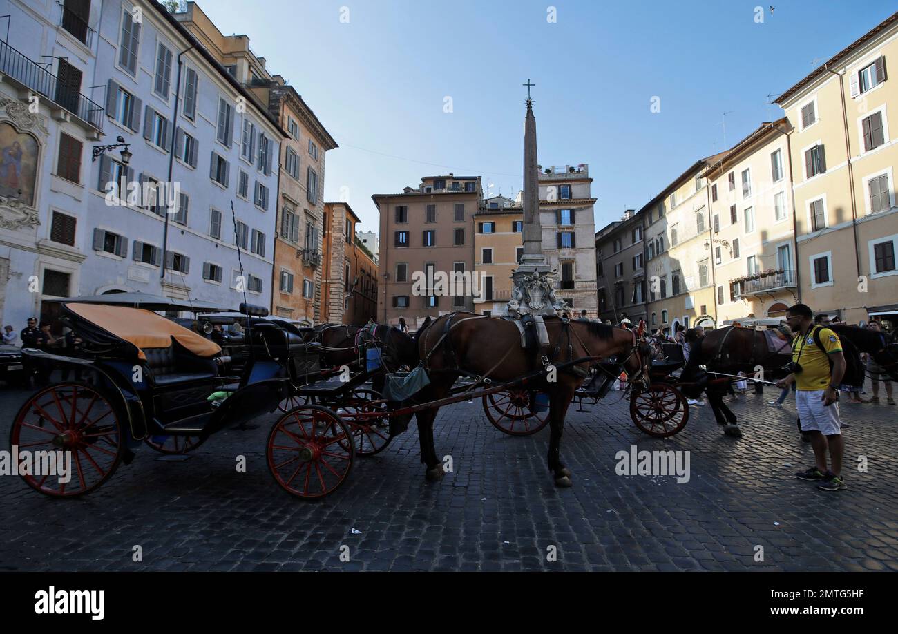 Horse-drawn carriages wait for tourists in Rome's Pantheon Square ...