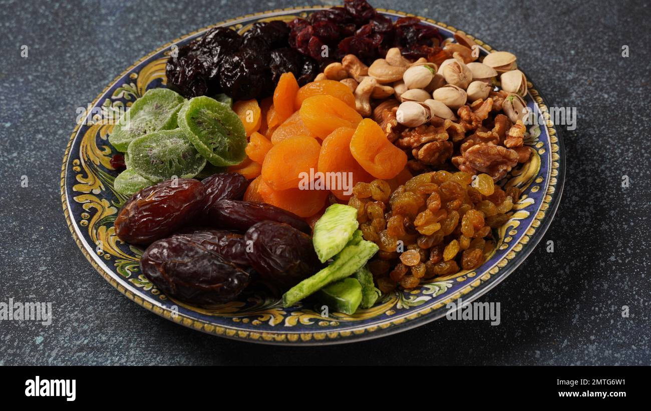 Assorted dry fruits: Dry plum, kiwi, raisins, nuts, pistachios. Tu ...