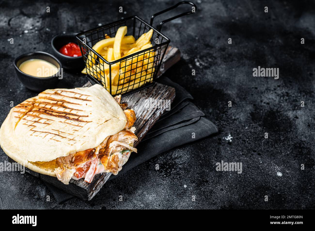 Turkish doner kebab in grilled pita bread with chicken meat. Black ...