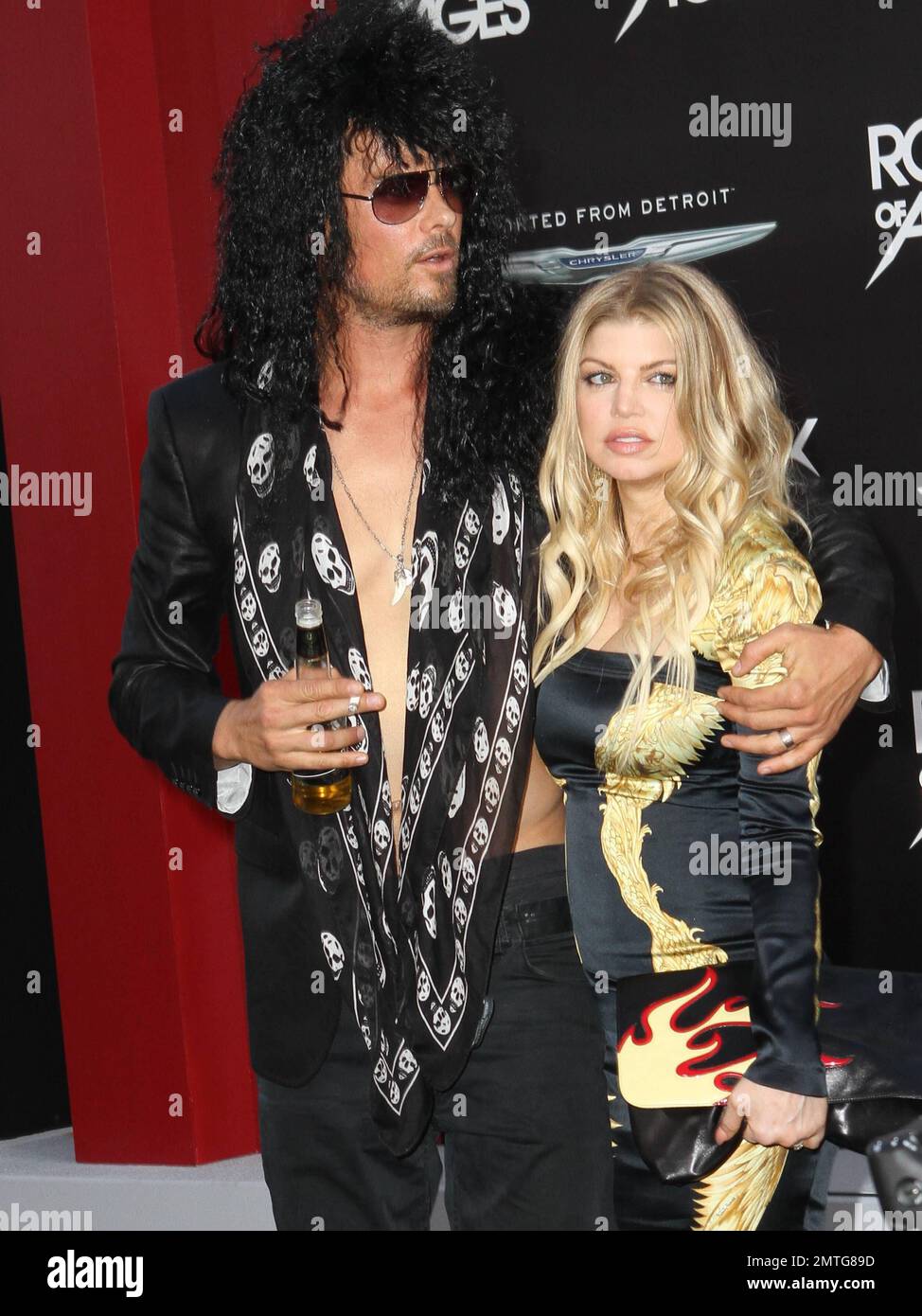 Josh Duhamel wears a rocker costume and carries a beer and cigarette as ...