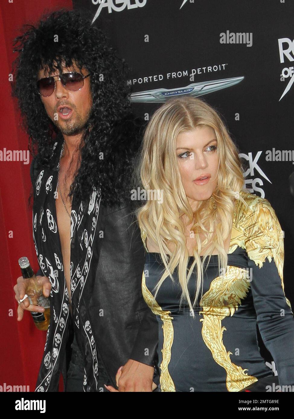 Josh Duhamel wears a rocker costume and carries a beer and cigarette as ...