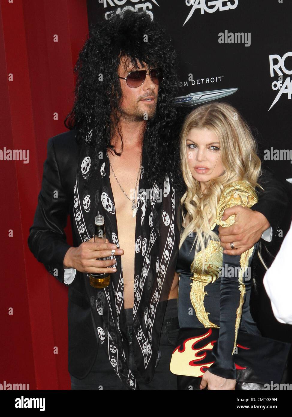 Josh Duhamel wears a rocker costume and carries a beer and cigarette as ...