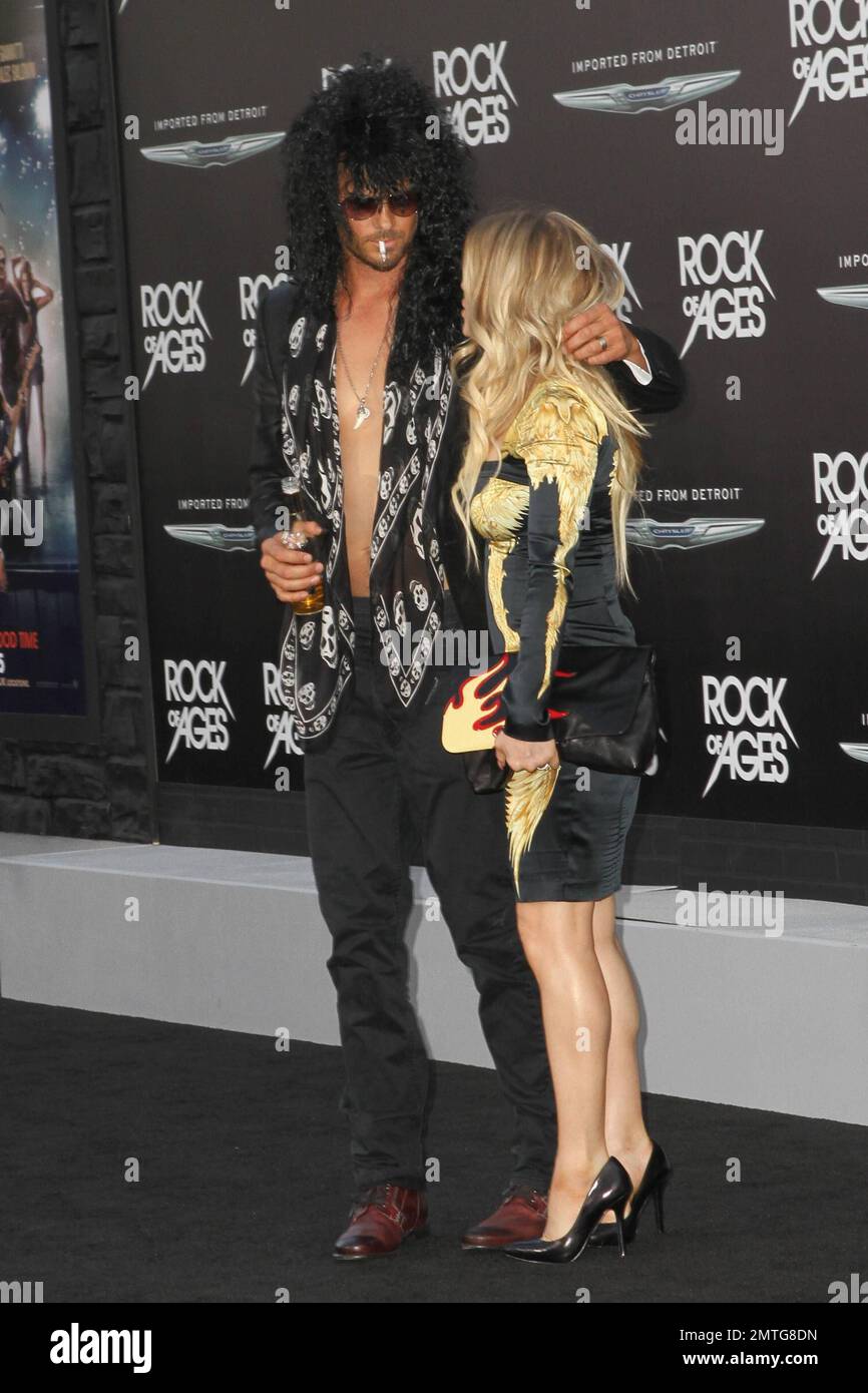 Josh Duhamel wears a rocker costume and carries a beer and cigarette as ...