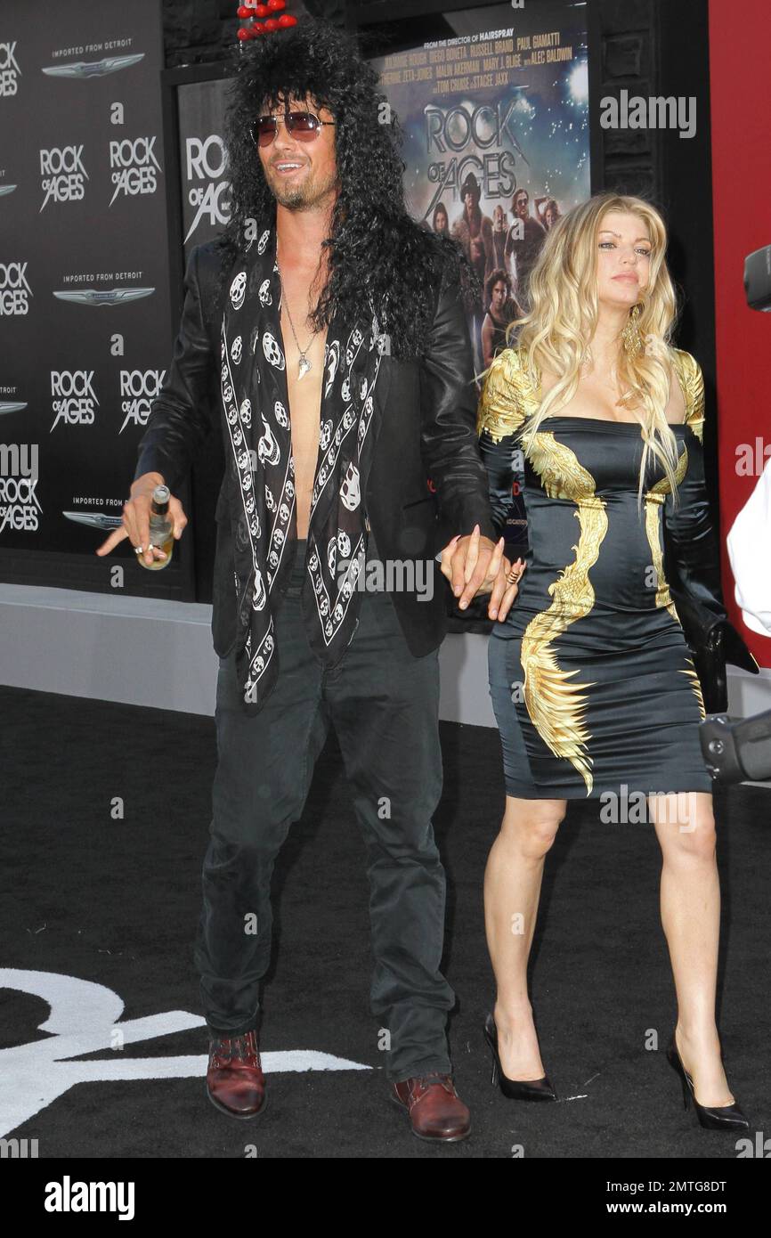 Josh Duhamel wears a rocker costume and carries a beer and cigarette as ...