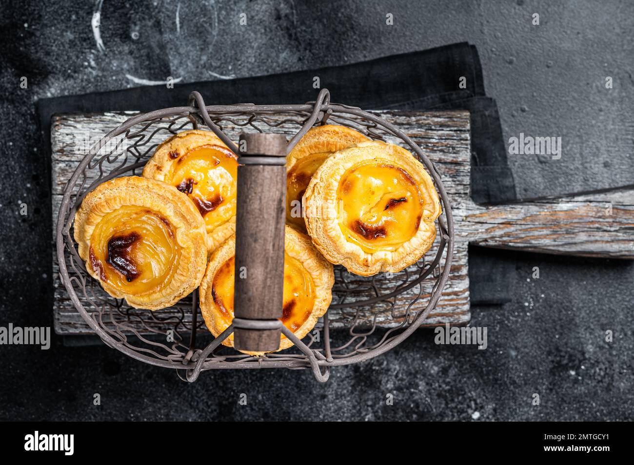 Traditional Lisbon Pasteis de nata in a basket. Black background. Top ...