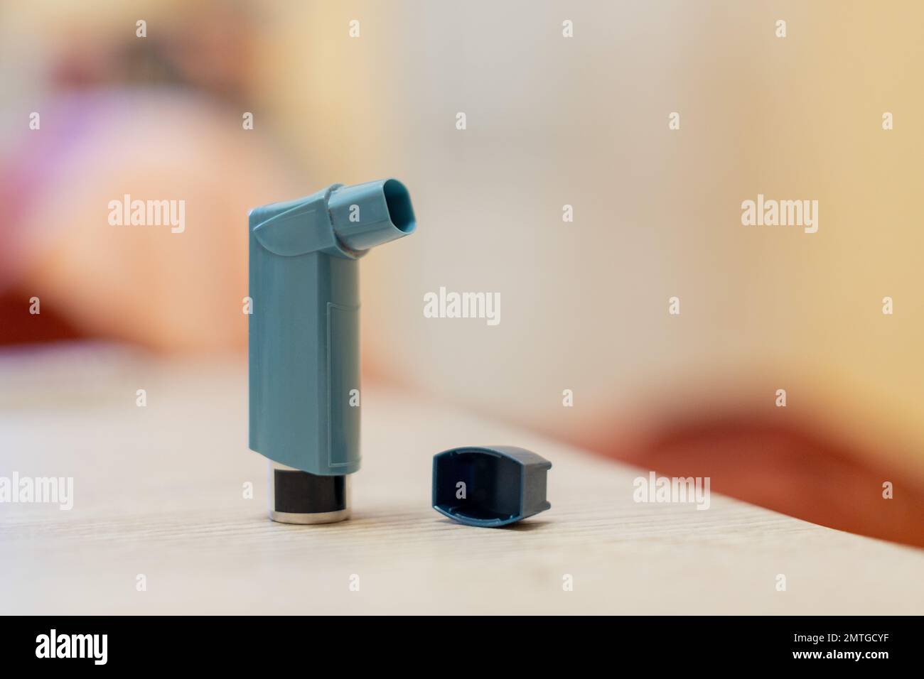 Inhalator with a open cap on a wood surface - Shallow focus Stock Photo ...