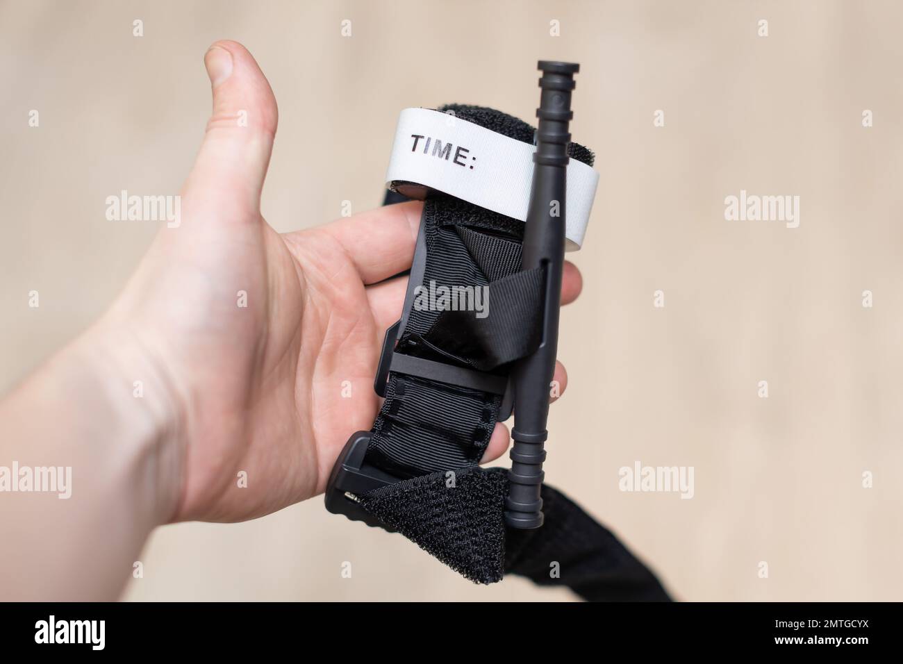 Used opened Tourniquet on a wooden surface Stock Photo - Alamy