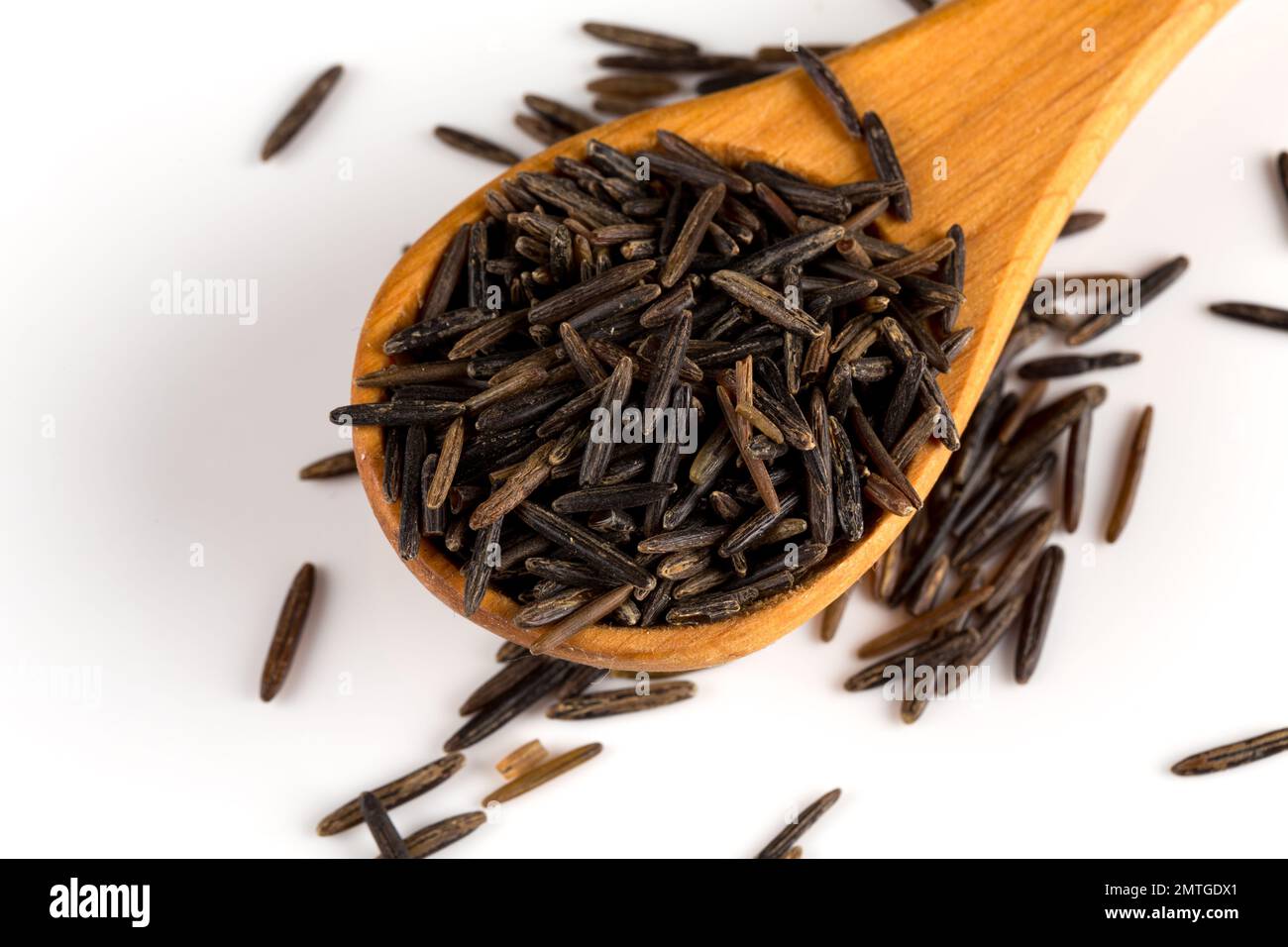Close-up of wild brown, black rice on white background Stock Photo - Alamy