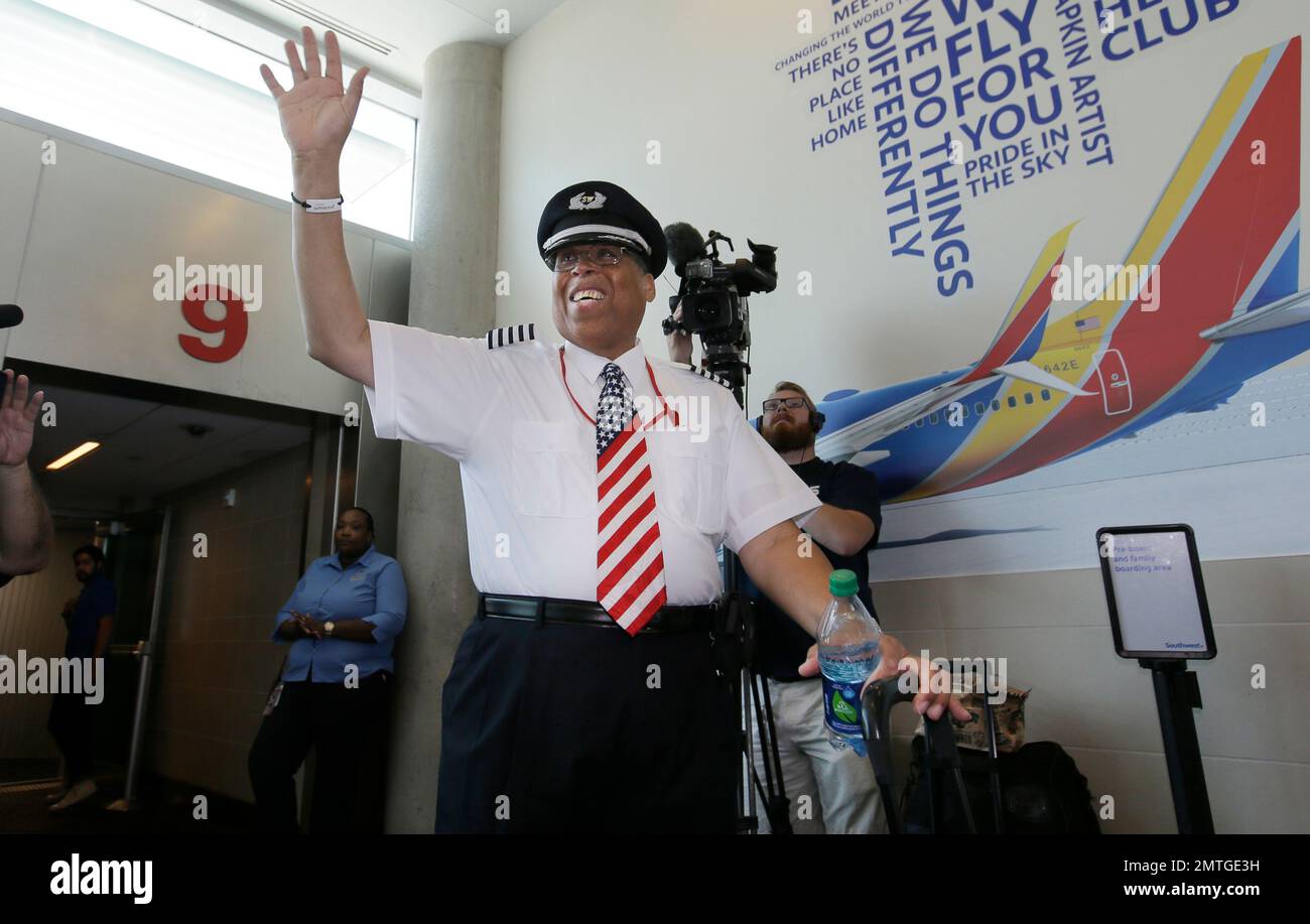 Southwest Airlines captain Louis Freeman waves before boarding a jet to ...