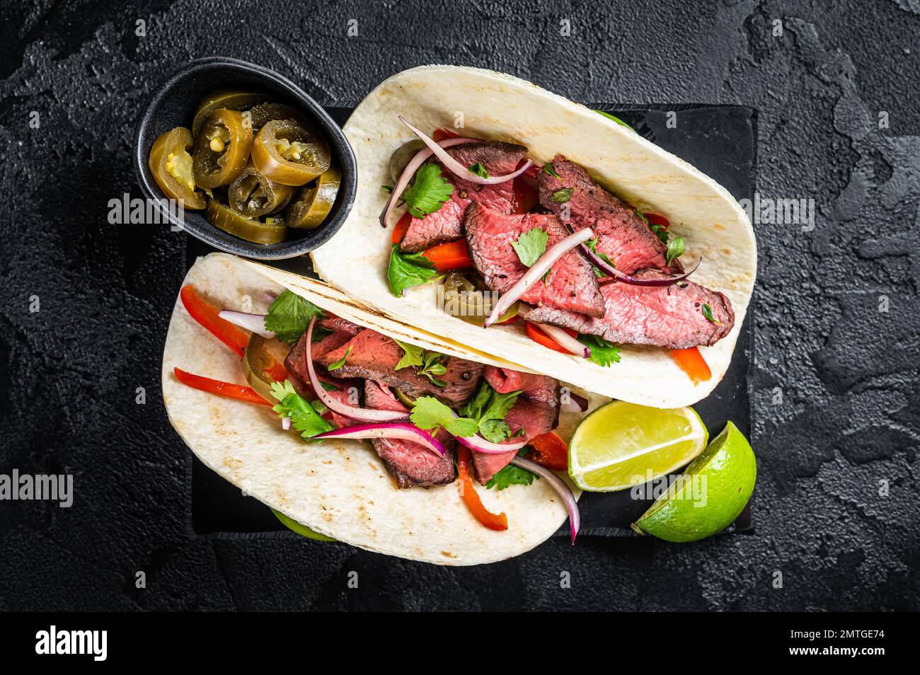 Mexican Steak Tacos with beef meat, cilantro, green sauce, jalapenos ...
