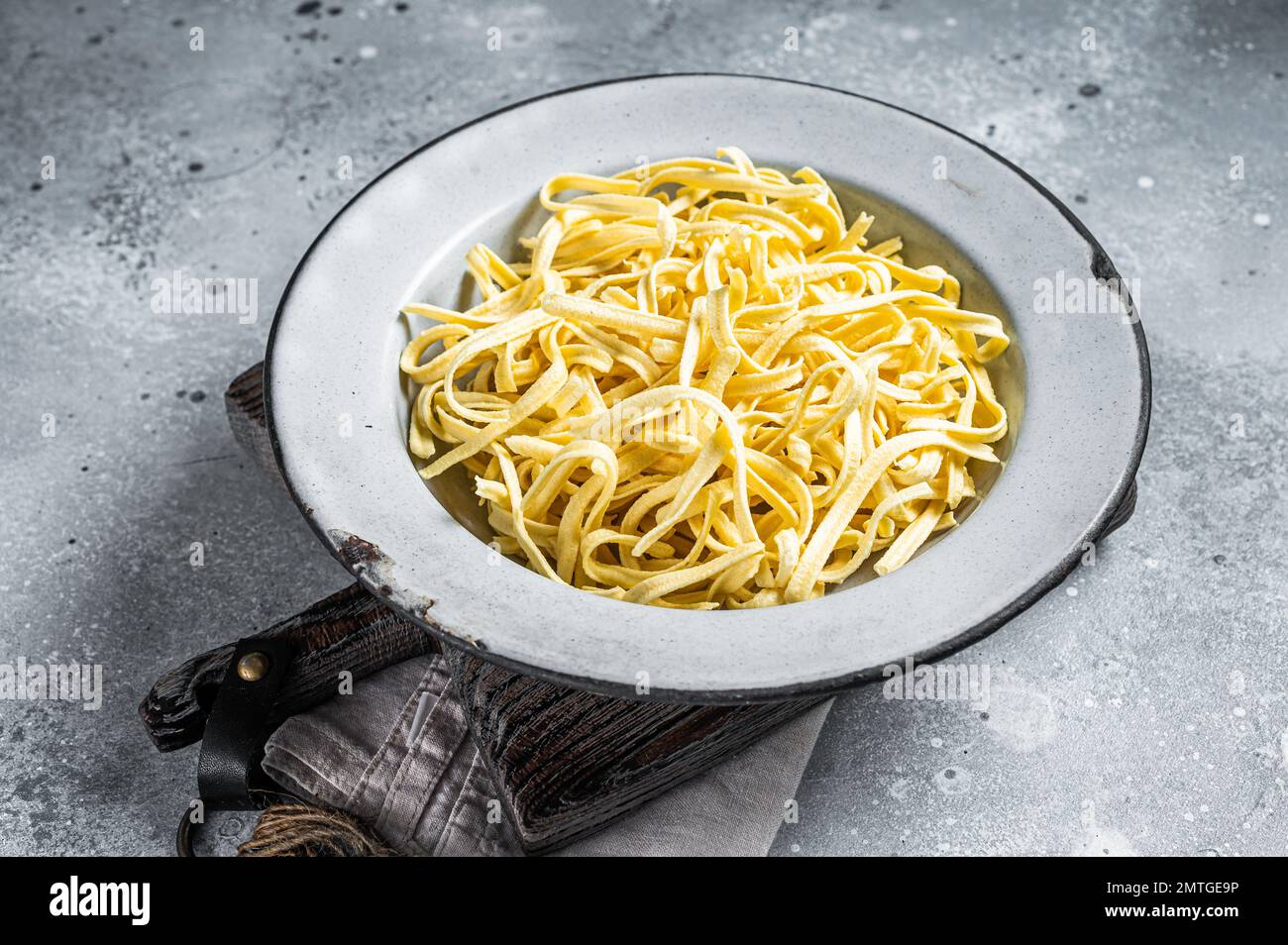 Raw dried spaetzle egg noodle. Gray background. Top view Stock Photo ...