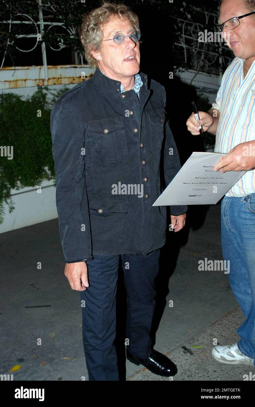 The Who frontman Roger Daltrey poses for photos with fans as he leaves ...