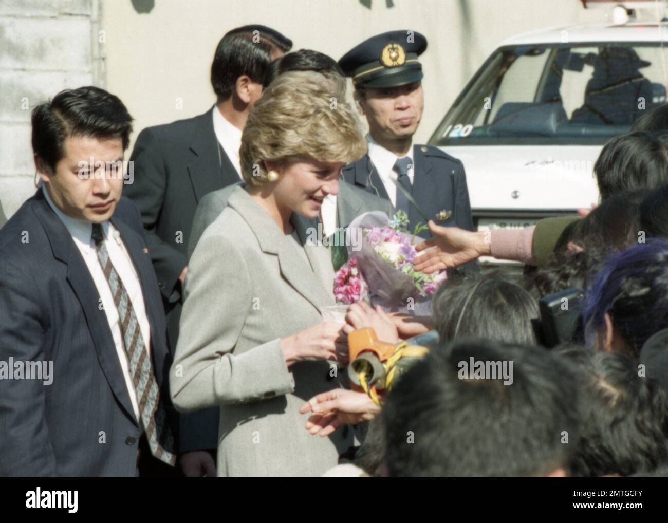 Princess Diana smiles as a Japanese admirer tries to reach for a ...