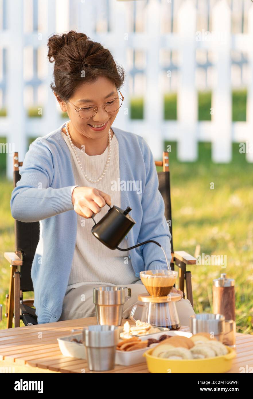 The elderly campsite drink coffee chat Stock Photo - Alamy
