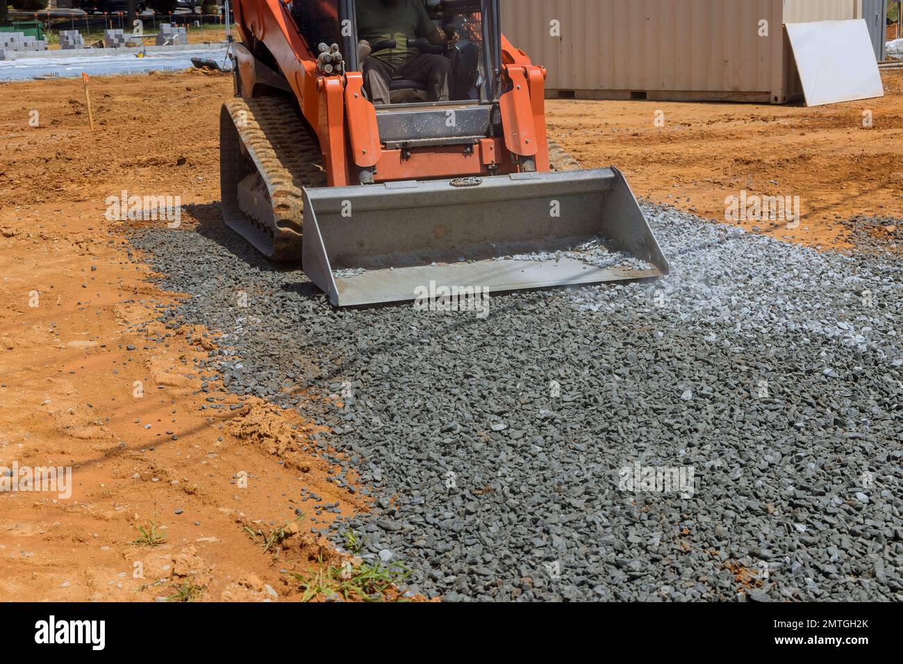 There is bucket full of crushed stone being loaded into an excavator as ...